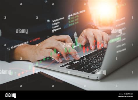 Business Using Computer Laptop And Analysing The Financial Data Graph