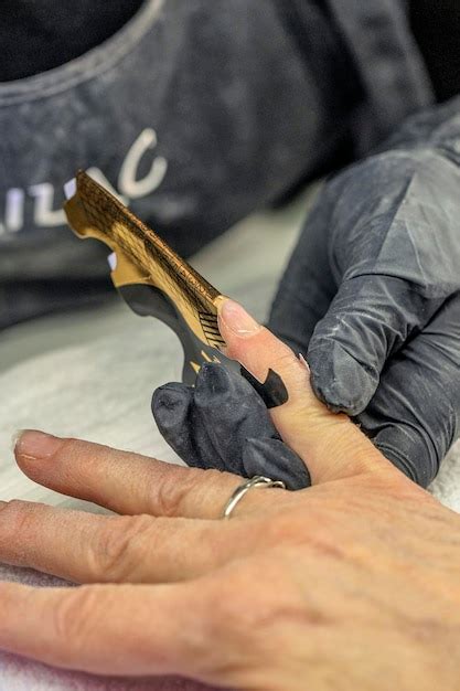 Premium Photo Manicurist Fixing Nails Of A Client
