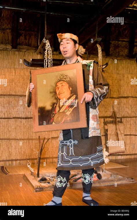 An Ainu Man Shows A Picture Of An Ainu Woman With Traditional Mouth