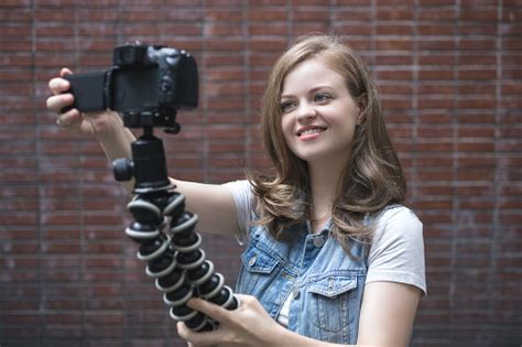 벽돌 벽 근처 카메라와 비디오 블로그 를 만드는 젊은 백인 소녀 여자 미소 거리에 대한 스톡 사진 및 기타 이미지 거리 디지털 뷰파인더 디지털 카메라 Istock