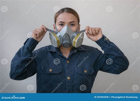 Portrait Of Asian Female Worker Wearing Gas Mask And Safety Helmet In