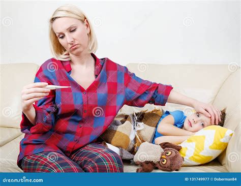 Mom Checking The Temperature Of Her Ill Son Stock Image Image Of