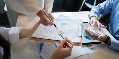 Business Team Collaboration On Data Analysis With Charts And Graphs In A Modern Office Setting