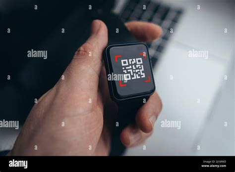 QR Code Concept Clock With A Symbol On The Screen In The Hands Of The
