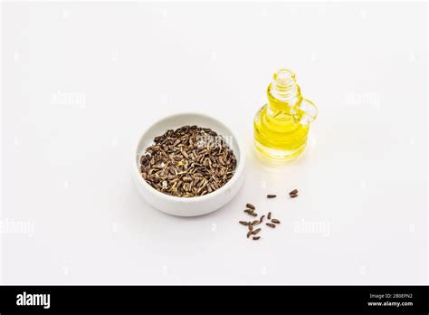 Burdock Oil And Seeds Isolated On White Background Beauty And Personal