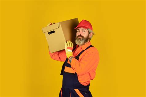 더 잘 사는 방법 골판지 상자 새 집으로 이사 새로운 거주지 구입 또는 방 수리 보일러 수트 포장 상자를 입고 남자 새 아파트로 이사하십시오 제복을 입은 수염 난 로더