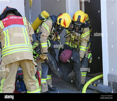 U S Army Garrison Fire Department Member Carry A Simulated Casualty During A Basement Fire