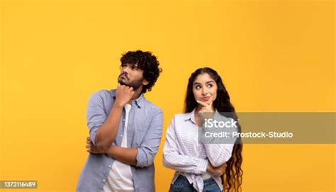 펜서디 인도 남자와 여자의 초상화 는 생각하고 여유 공간을 찾고 턱을 만지고 노란색 배경 사색에 대한 스톡 사진 및 기타 이미지 Istock