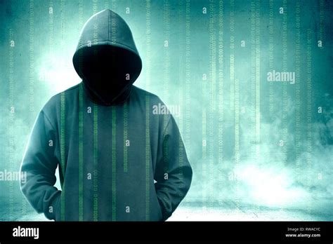 Hacker In Black Hoodie Standing With Binary Code On Virtual Screen Over