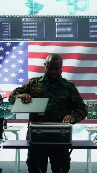 Vertical Military Officer In A High Tech Control Center Engages In Cybersecurity Operations