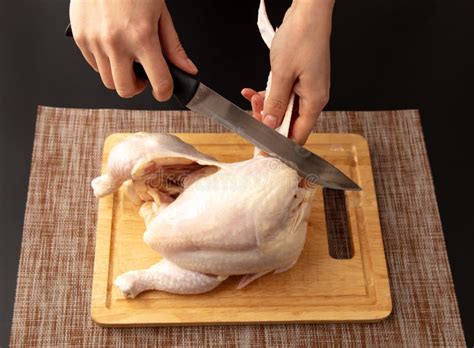Cutting Chicken Carcass On A Board On A Black Background Stock Image
