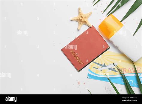 Composition With Passport Ticket And Bottle Of Sunscreen On White