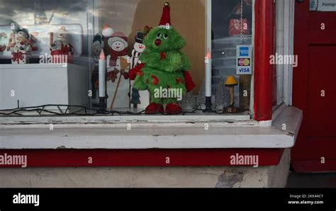 A Remarkably Tatty Christmas Display In An Old Shop Window Strange Looking Figures And A Few