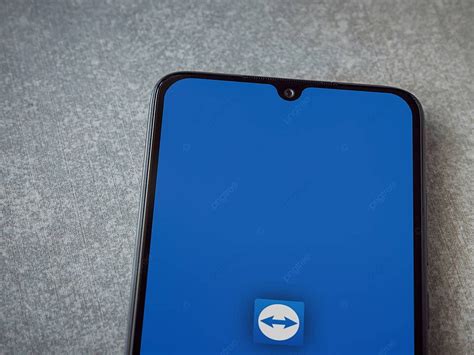 The Launch Screen Of Teamviewer App Featuring A Logo Displayed On A Black Background Photo And