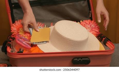 Womans Hands Arranging Items Peach Colored Suitcase Stock Photo