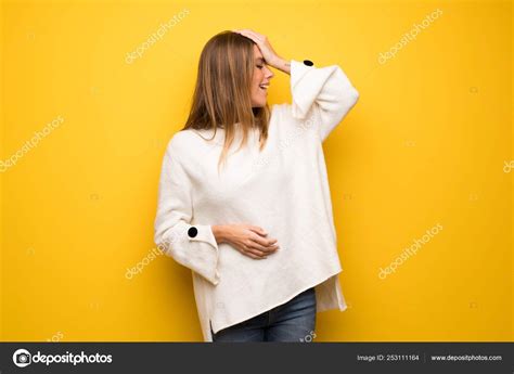 blonde woman yellow wall has just realized something has intending