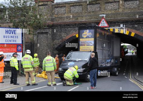 An Advertising Trailer Lorry Gets Stuck Under The Railway Bridge In