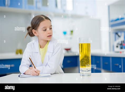 Portrait Of Girl Scientist Writing Down Results Of Experiment In Lab Stock Photo Alamy