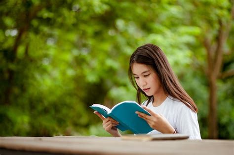Premium Photo Asian Girl Reading Book At Park In Summer Sunset Light