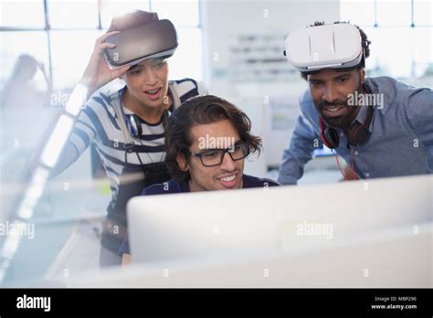 Computer Programmers Programming Virtual Reality Simulators At Computer