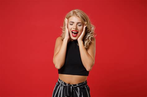 빨간 배경 스튜디오 초상화에 고립 된 포즈 검은 옷을 입고 기뻐하는 젊은 여성 소녀 사람들은 진지한 감정 라이프 스타일 개념