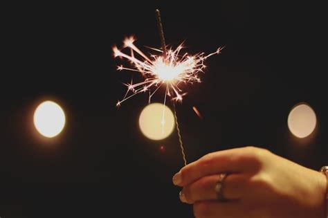 Premium Photo Womans Hand Holding A Sparkle In The Dark