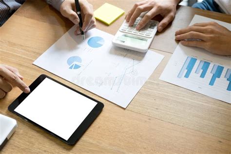 Two Businessman Working Use Computer And Analysis Paper Graph On Stock