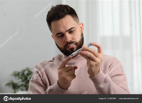 Diabetes Test Man Checking Blood Sugar Level Lancet Pen Home Stock Photo NewAfrica 711807998