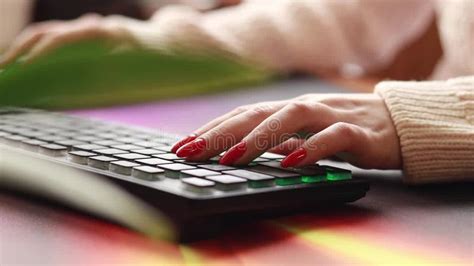 Hands On The Keyboard Close Up Woman Is Typing On A Keyboard Surrounded By Home Flowers Stock