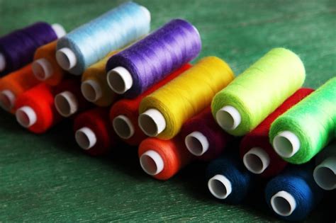 Premium Photo Multicolor Sewing Threads On Wooden Background