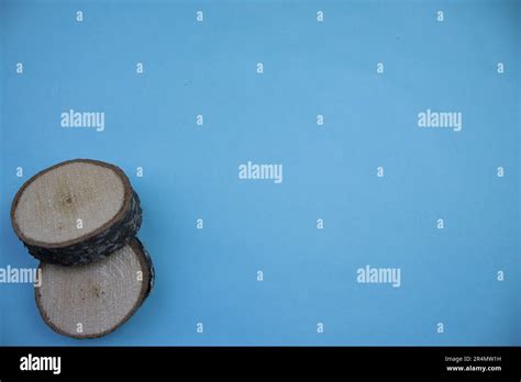 Small Round Logs Photographed From Above Placed On The Edge Of A Blue
