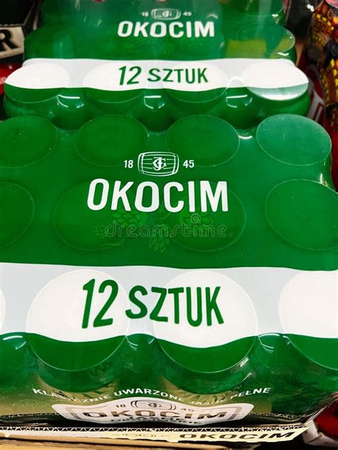 Pack Of Twelve Green Labeled Okocim Beer Beverages With Visible Brand