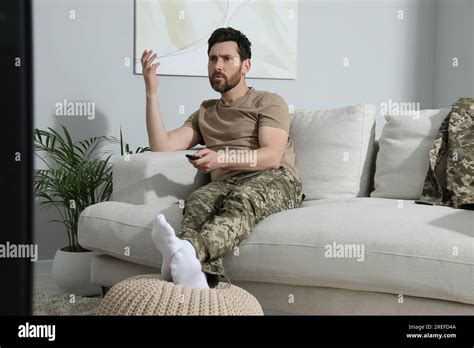 Emotional Soldier Watching Tv On Sofa In Living Room Military Service