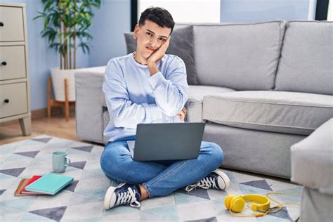 Non Binary Person Studying Using Computer Laptop Sitting On The Floor