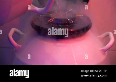 Scientist Opens A Cryogenic Container With Medical Samples And Pour Liquid Nitrogen Liquid