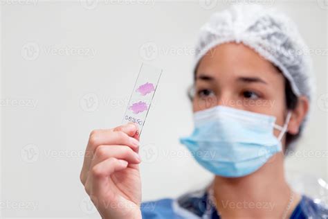 Young Female Scientist Preparing Slides With Paraffin Embedded Sections For Pathological