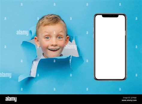 Happy Cute Boy Is Having Fun Played On Blue Background Wall Climbs