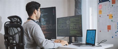Asian Male Software Developer Coding Program On Desktop Computer Man