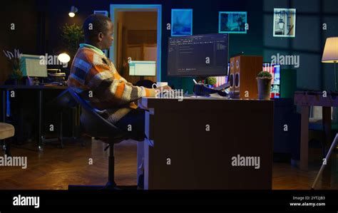 programmer in home office concentrating on finding bugs while he codes