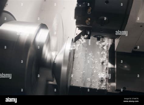 CNC Lathe Machine Or Turning Machine Cutting Parts At The Steel Shaft Elements Cutting Process