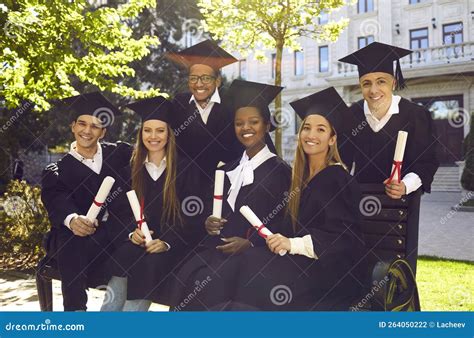 Outdoor Group Portrait Of Happy Diverse College Or University Graduates