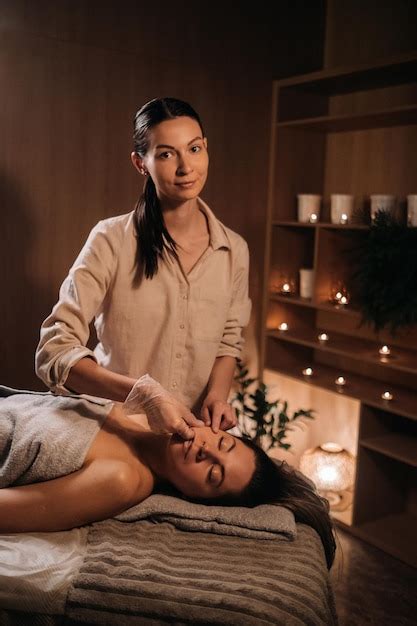 Premium Photo A Cosmetologist Girl Does A Facial And Neck Massage To