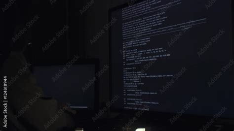 hacker in hood cracking code using computers in dark room stock ビデオ