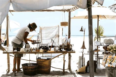 A Beachside Shop With A Person Arranging Items On The Counter Premium