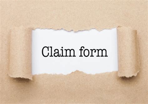 Premium Photo Claim Form Text Appearing Behind Torn Brown Paper Envelope