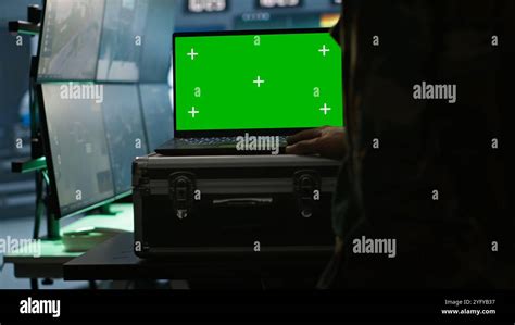 Army Specialist Working In War Room Operating Surveillance Tech Evaluating Target Data On