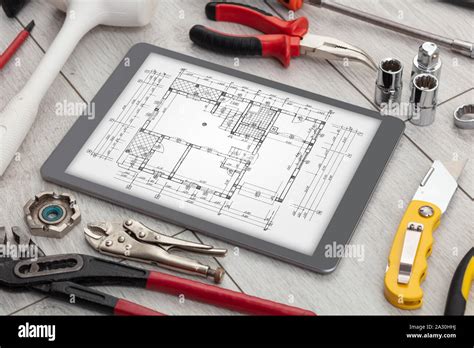 Tablet With Construction Tools And Blueprint Concept Stock Photo Alamy