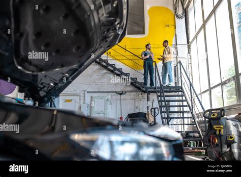 Two People Standing On The Stairs In The Garage Stock Photo Alamy