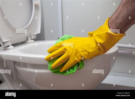 Man Cleans A Bathroom Toilet With A Green Brush Stock Photo Alamy