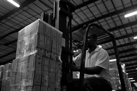 Man Working At Warehouse And Driving Forklift Premium Ai Generated Image